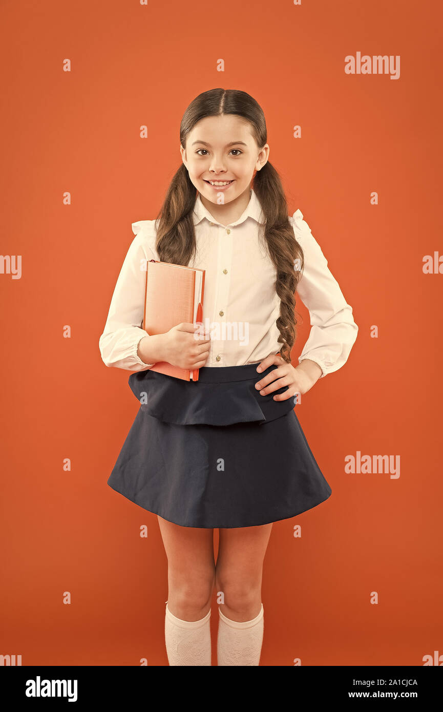 Schoolgirl studying textbook. Interesting book for children ...