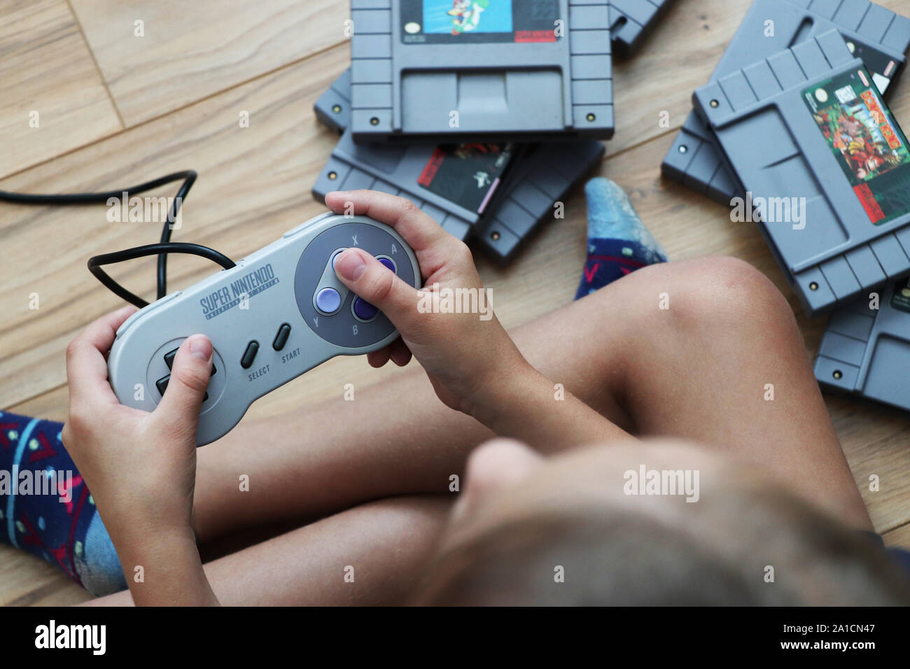 A little child playing original Super Nintendo Stock Photo - Alamy