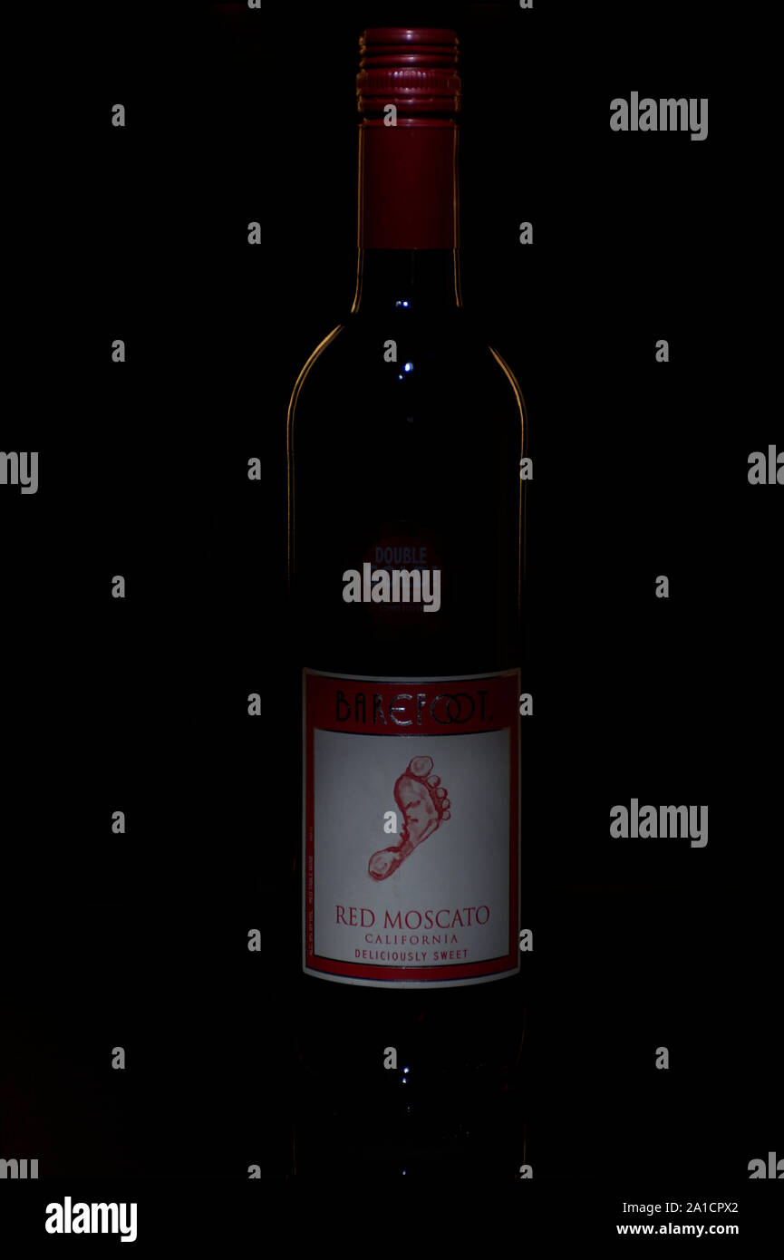 Bottle of red wine with white label and cap highlighted and black ...