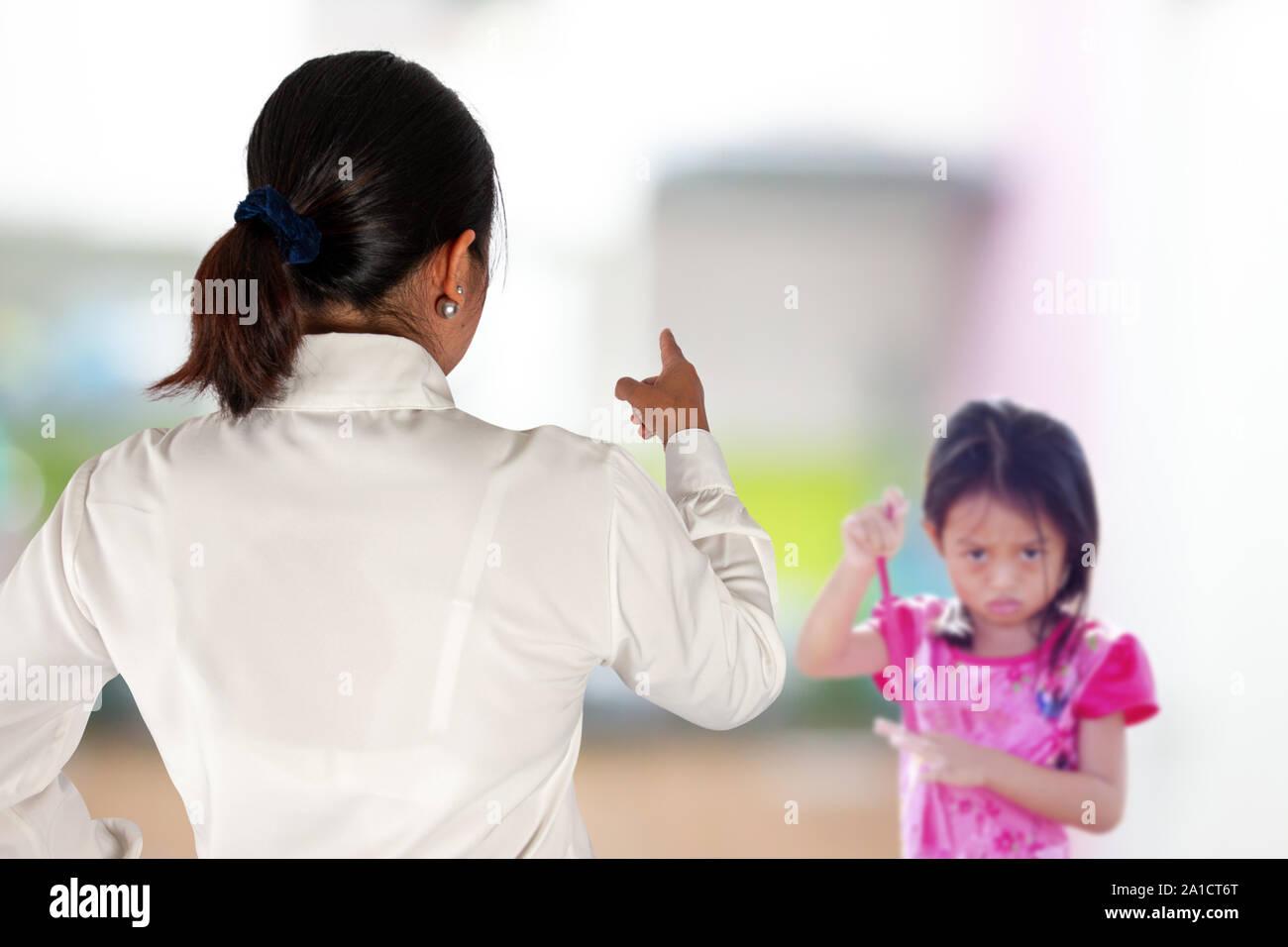 Mother scolds her child because of playing naughty and refusing to obey ...