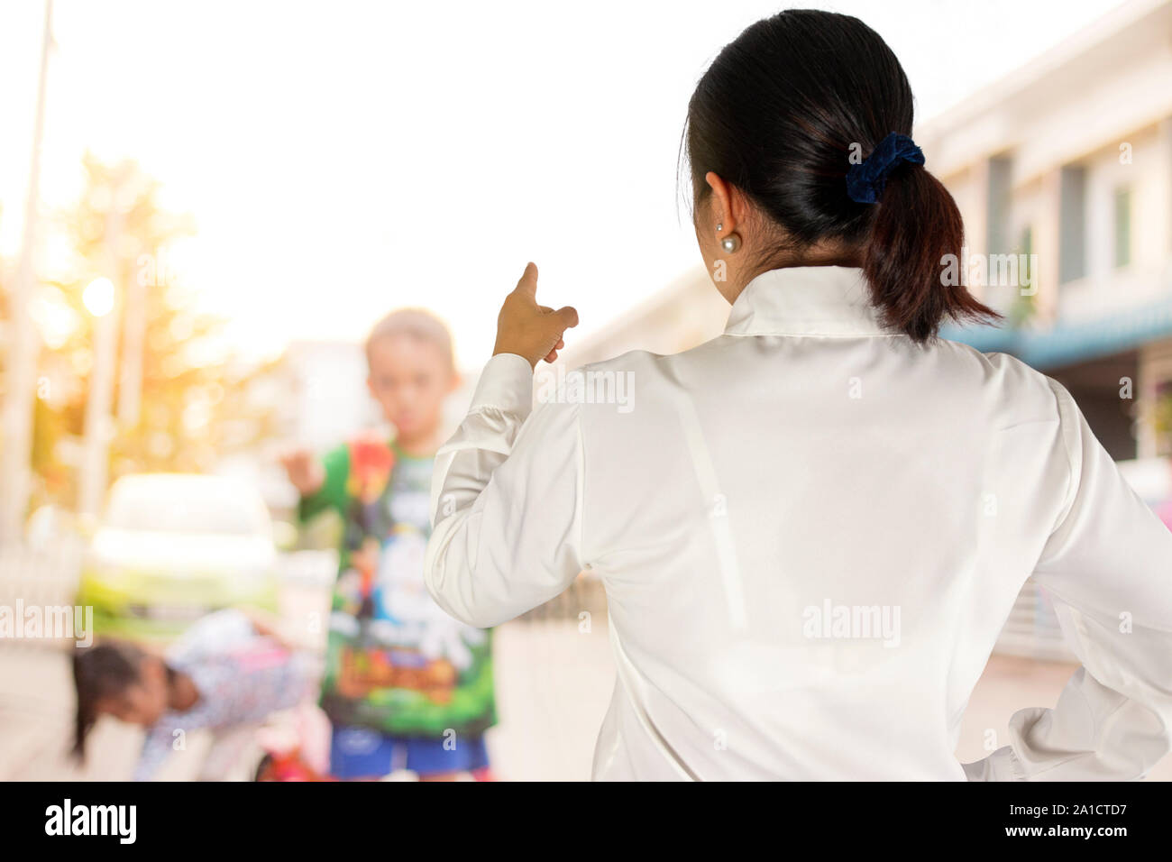 Mother scolds her child because of playing naughty and refusing to obey ...