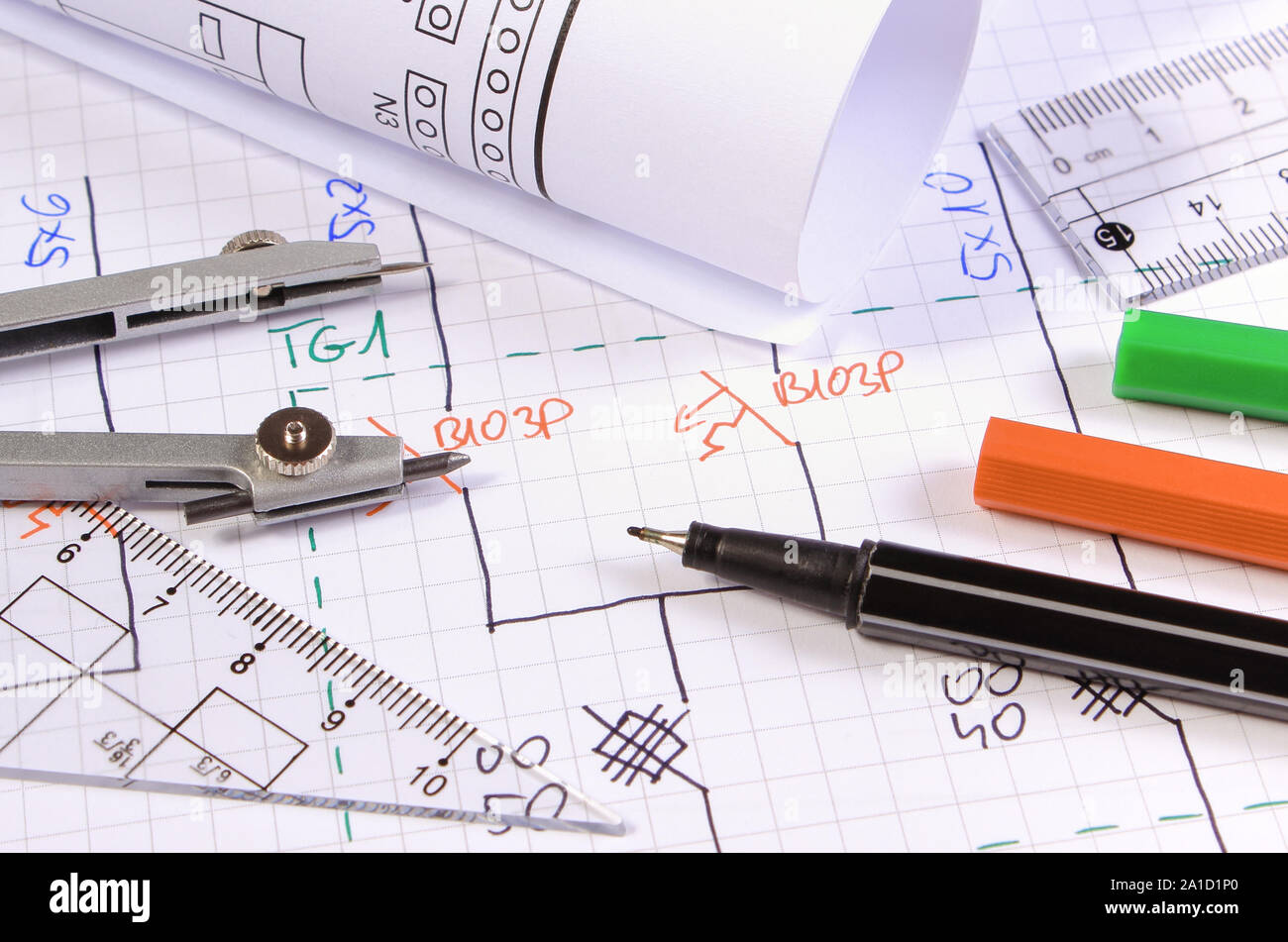 Rolls of electrical diagrams and accessories for drawing lying on ...