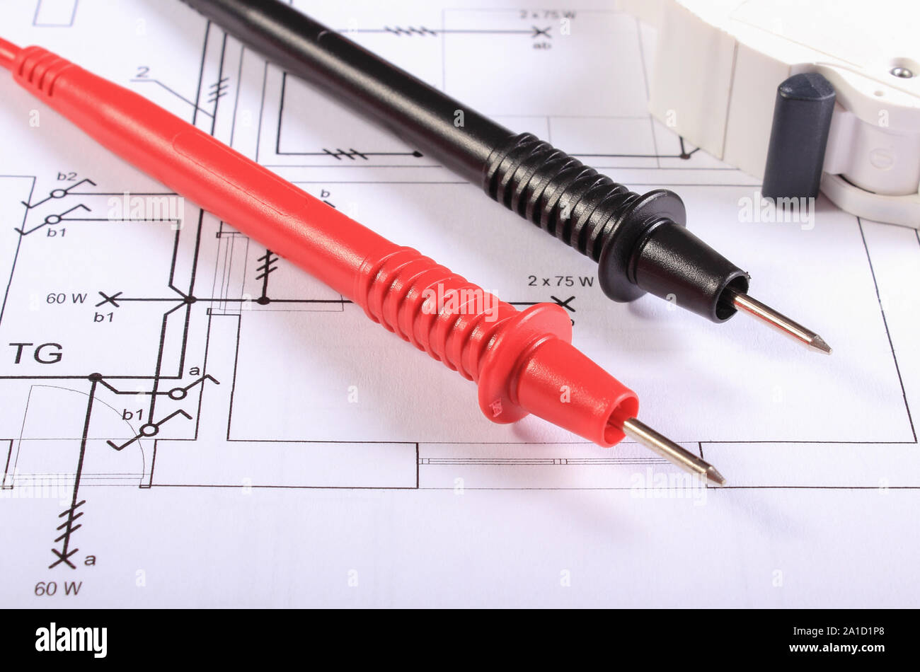 Cables of multimeter and electric fuse on construction drawing of house ...