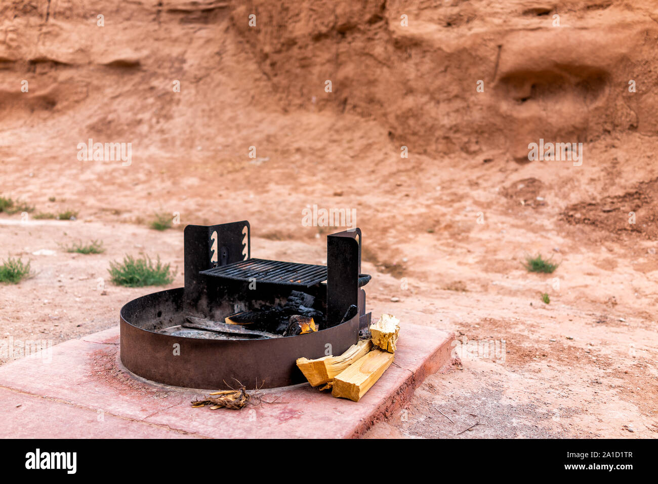 Campfire fire pit grill by logs and desert landscape with nobody in ...