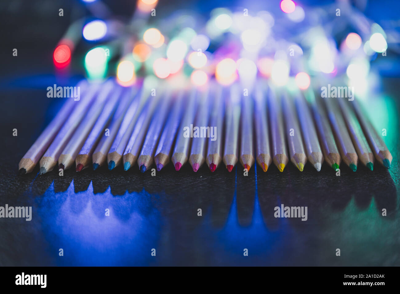 creativity and fun concept, assortment of coloured pencils on dark ...