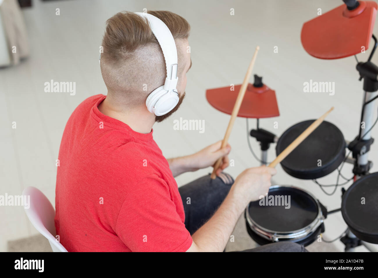 People, drums and hobby concept - Close up side view of musician with ...