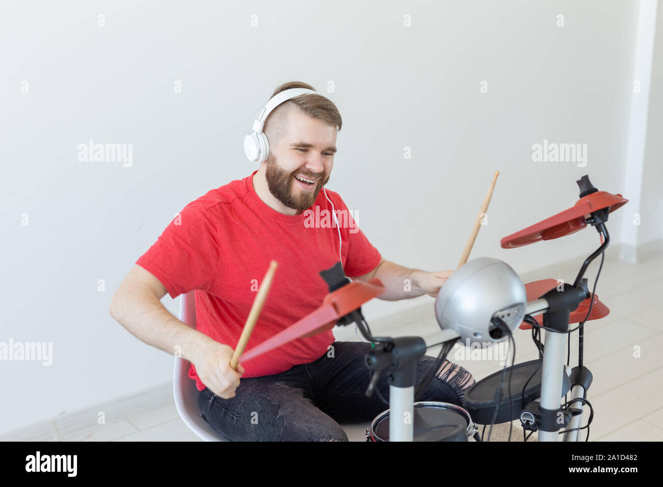 People, music and hobby concept - Man dressed in red t-shirt playing on ...