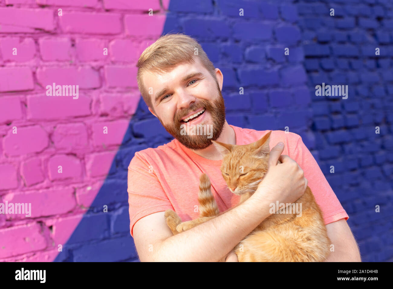Pet owner and friendship concept - Handsome man is holding and hugging ...