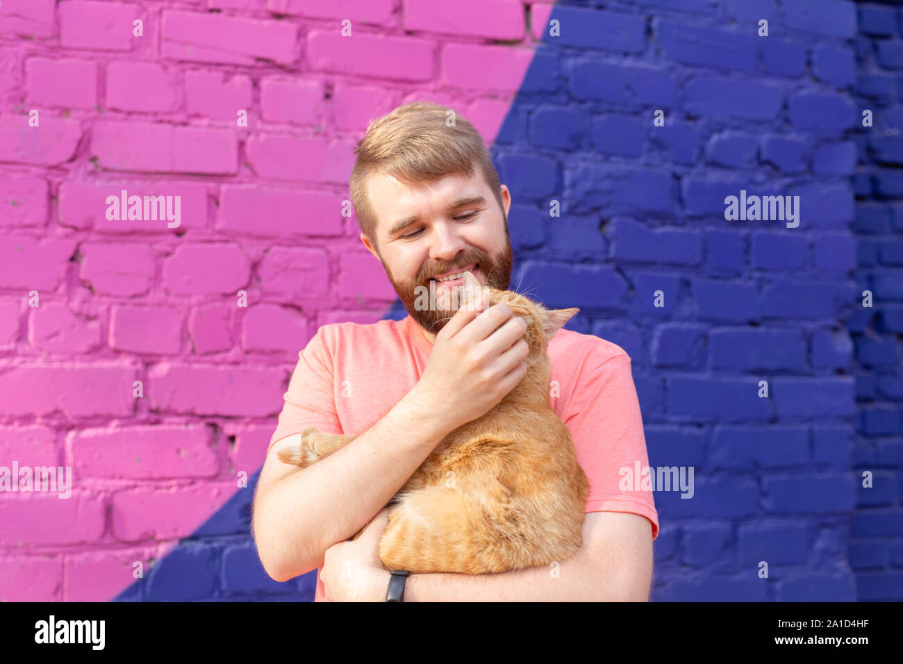 Pet owner and friendship concept - Handsome man is holding and hugging ...