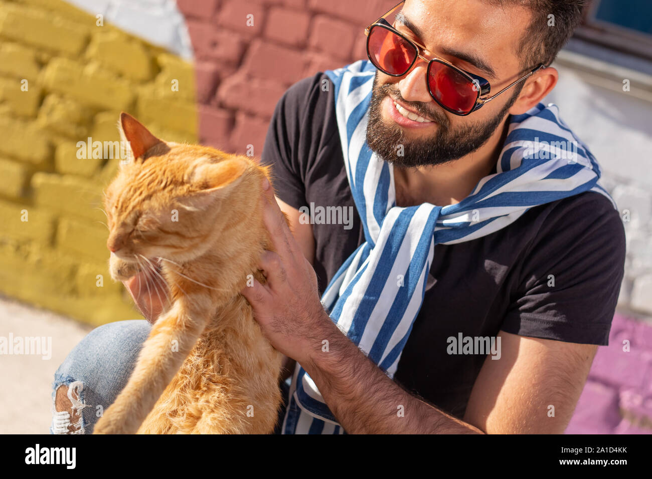Pet owner and friendship concept - Handsome man is holding and hugging ...