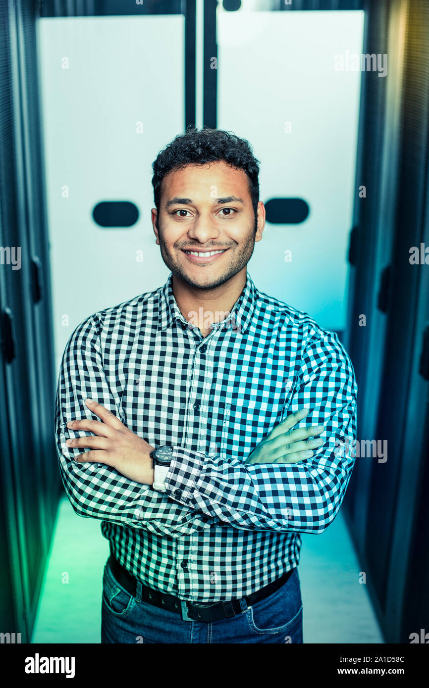 Positive handsome nice man standing cross handed Stock Photo - Alamy