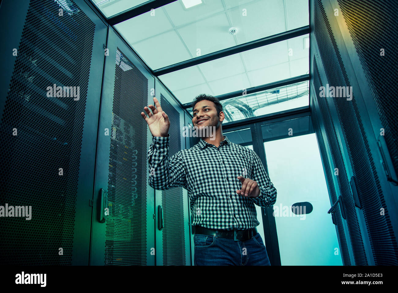 Low angle of a positive smart man using virtual technology Stock Photo ...