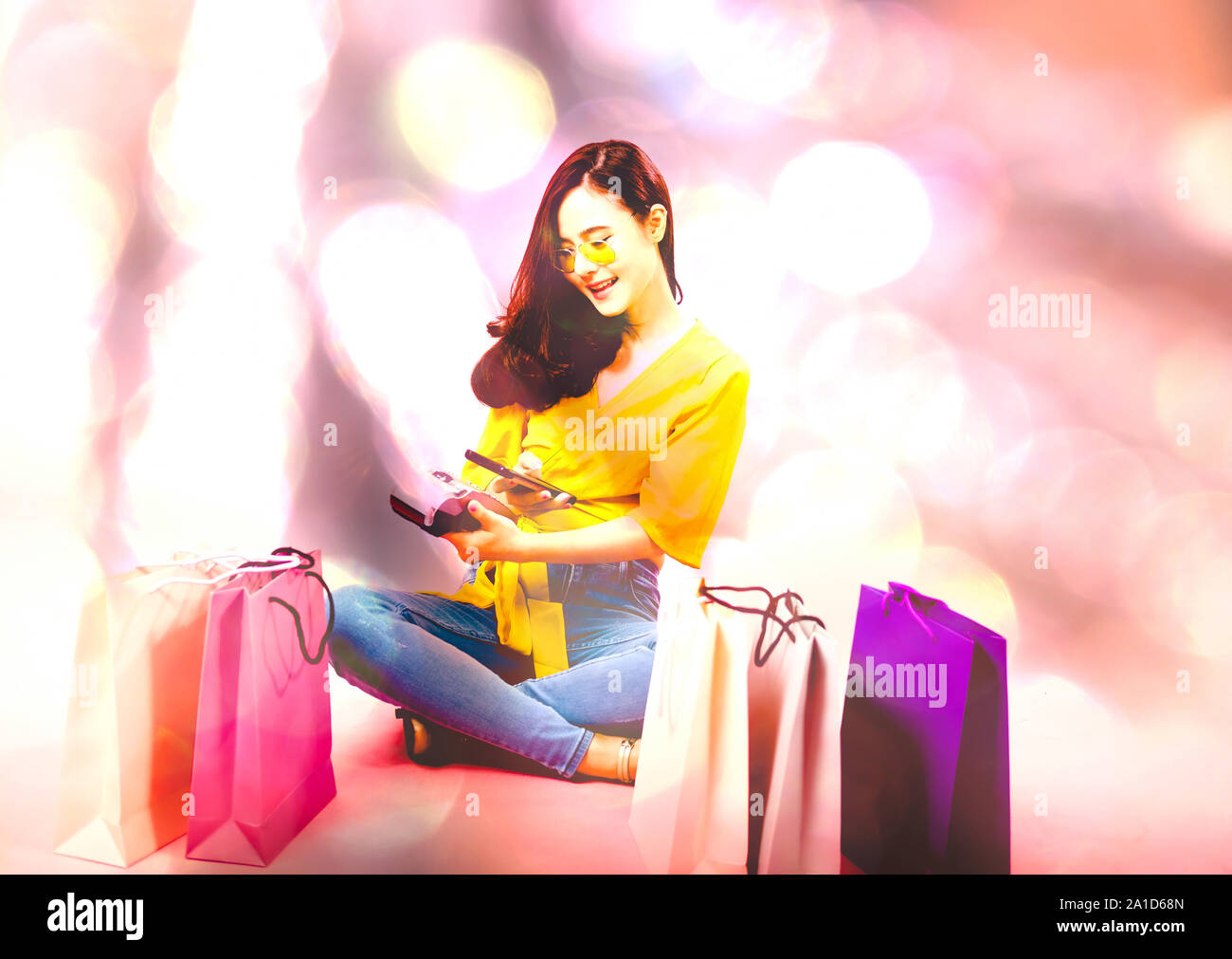 woman with smartphone & credit card swiping machine. shopping lifestyle ...