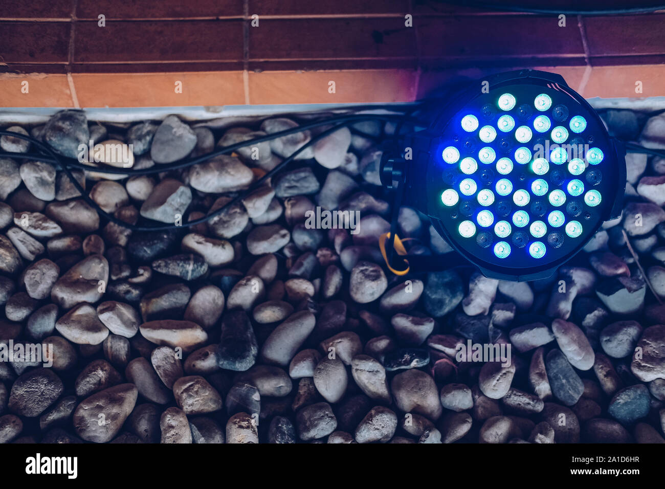 ground spotlight installed on stone rock floor Stock Photo - Alamy