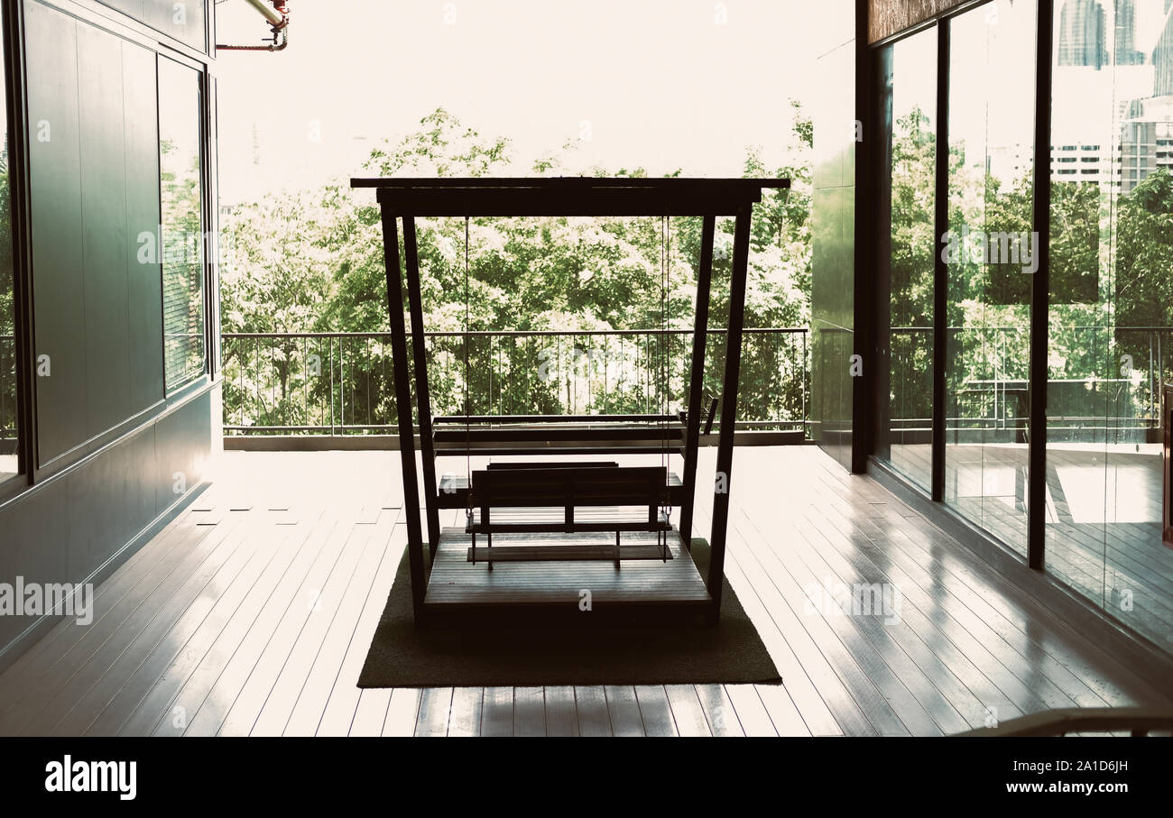 wooden rocking chair bench on terrace patio for relaxing in building ...