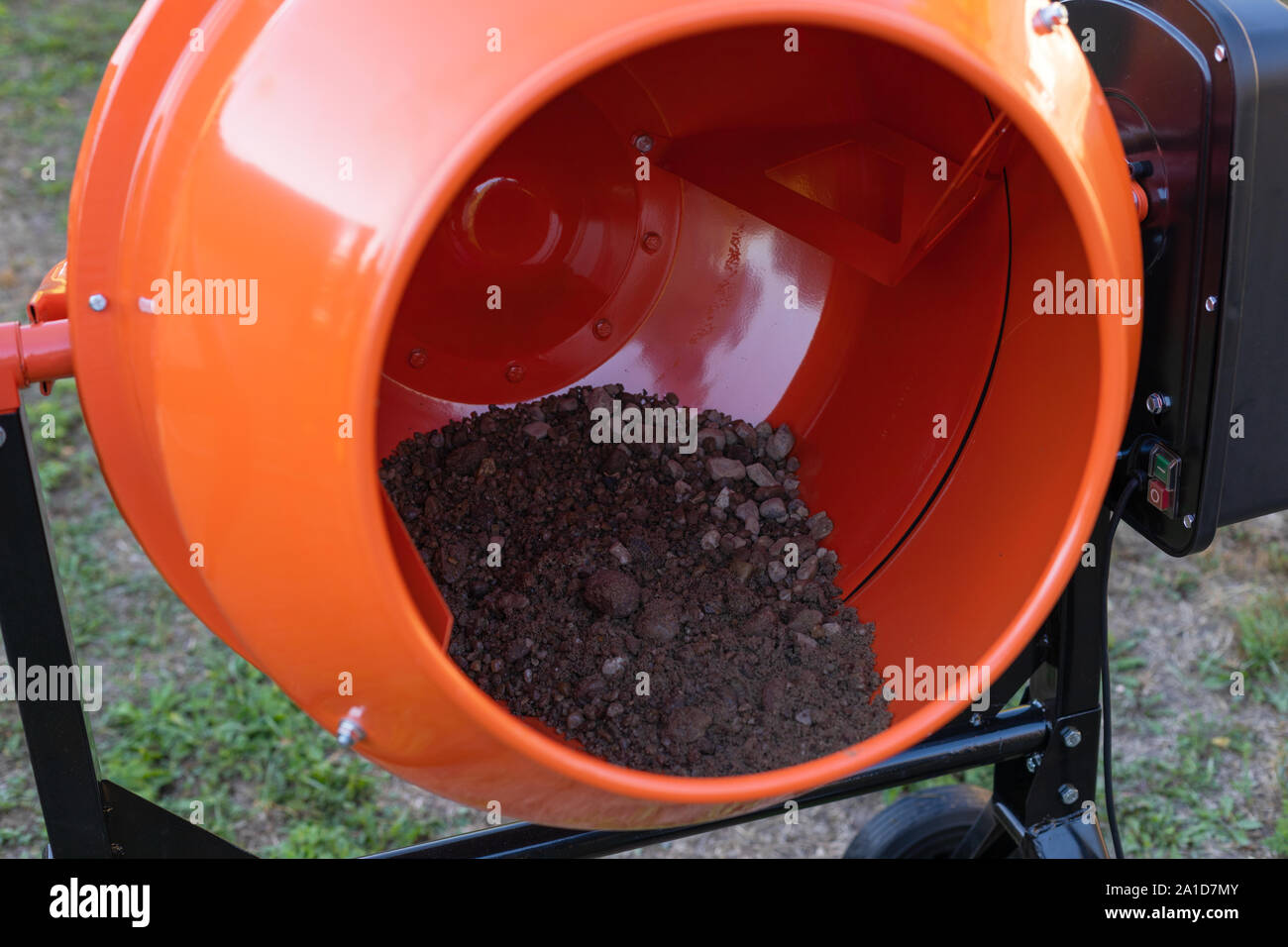 Picture of a brand new and clean orange concrete mixer ready to making ...