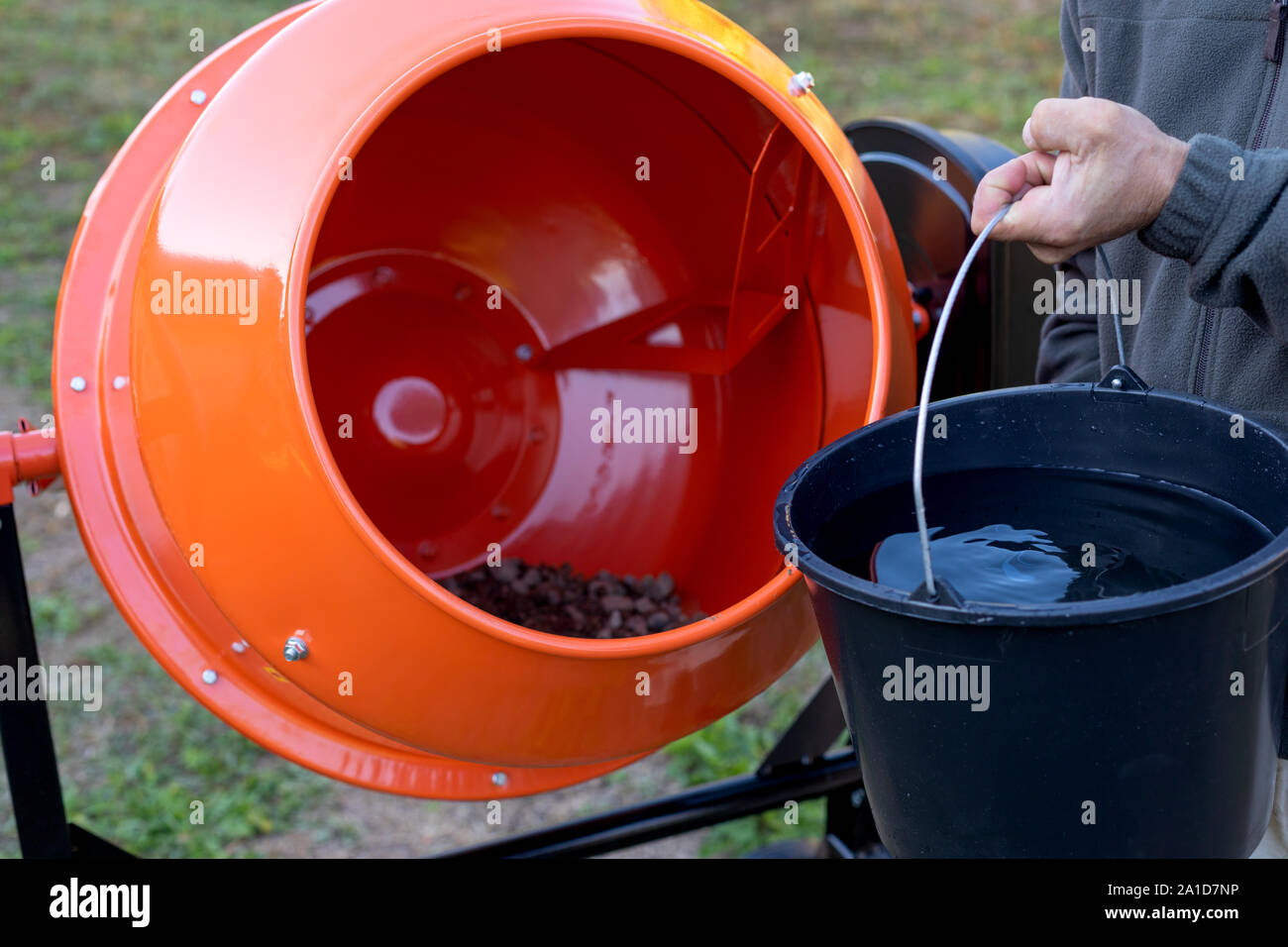 Picture of a brand new and clean orange concrete mixer ready to making ...