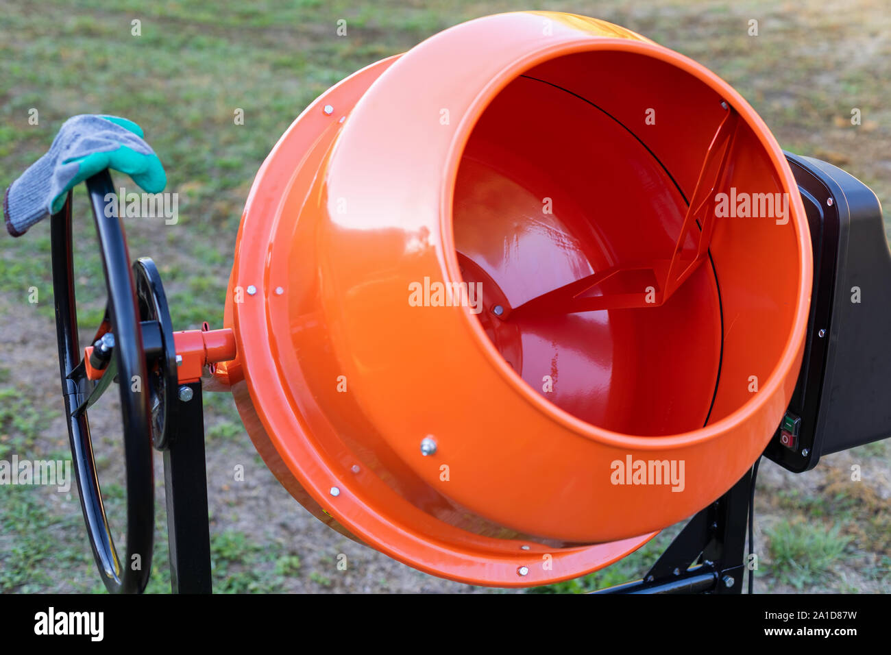 Picture of a brand new and clean orange concrete mixer ready to making ...