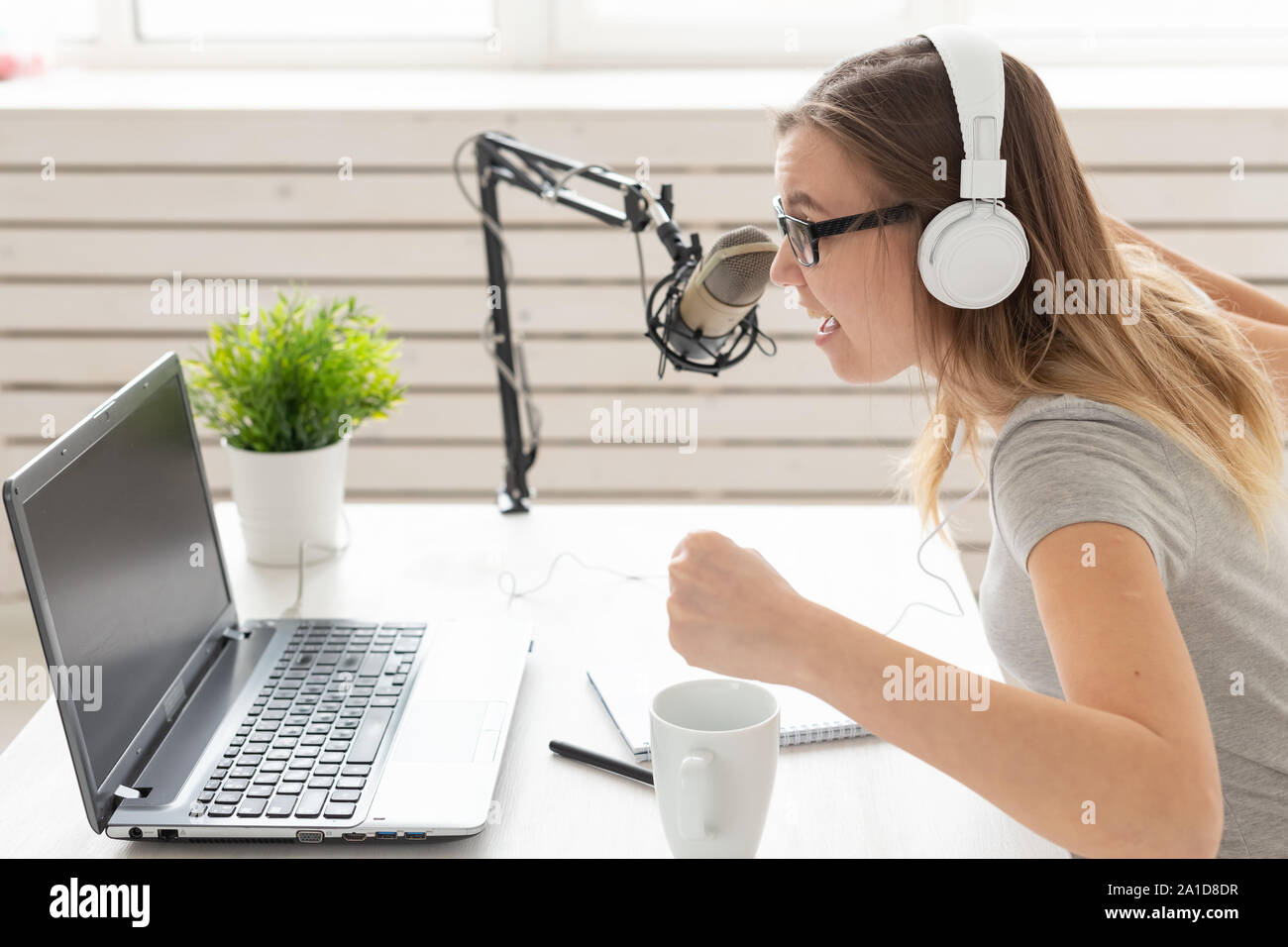 Music, dj, blogging and broadcasting concept - Female radio host with a ...