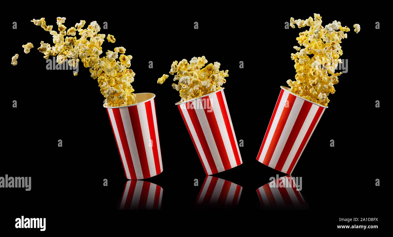 Set of paper striped buckets with popcorn isolated on black background ...