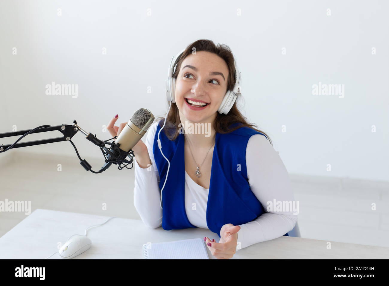 Podcasting, music and radio concept - woman speaking on the radio ...