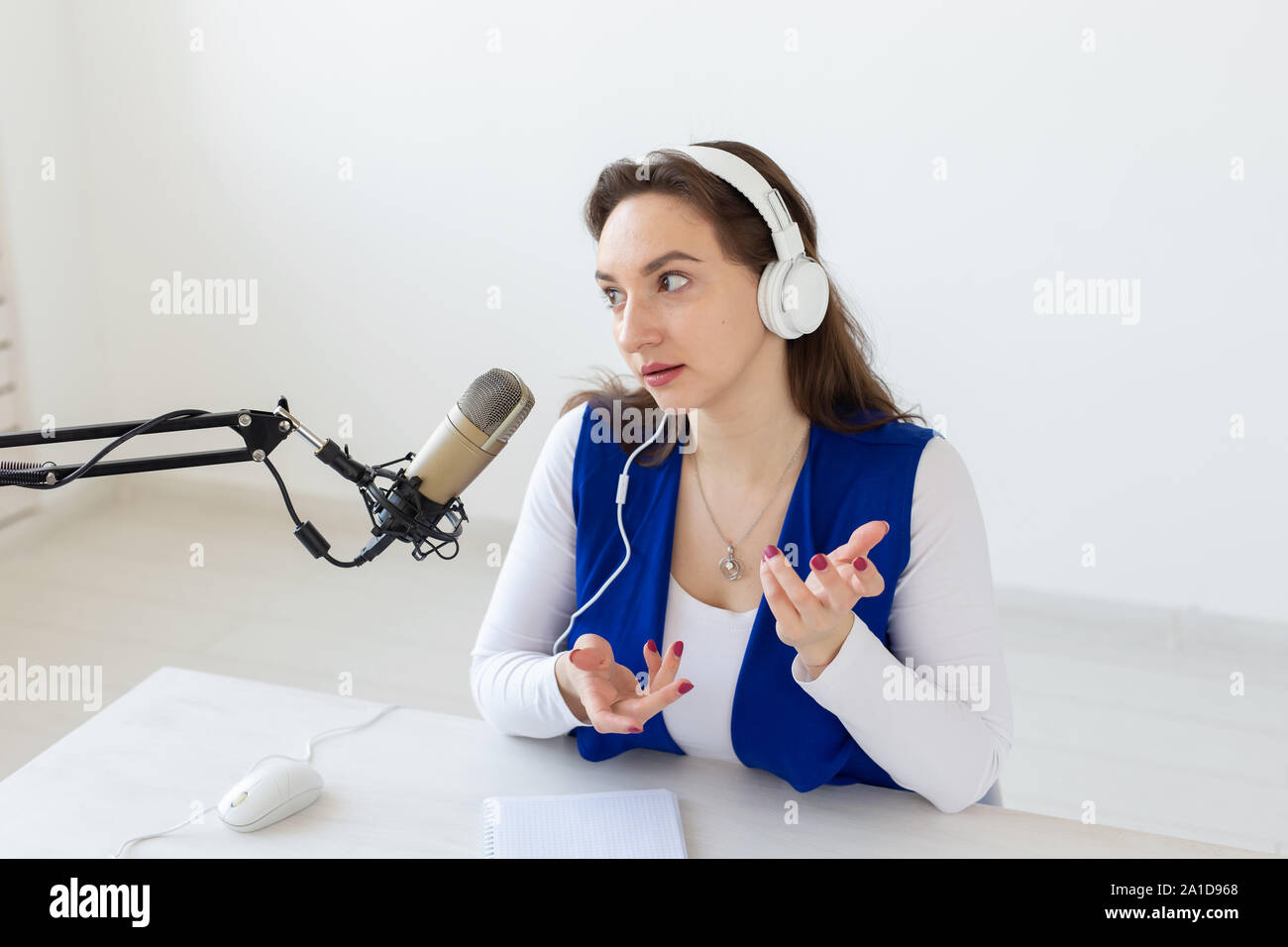 Podcasting, music and radio concept - woman speaking on the radio ...