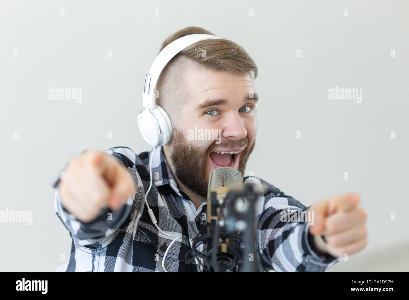Radio, DJ concept - Man with microphone and big headphone is smiling ...