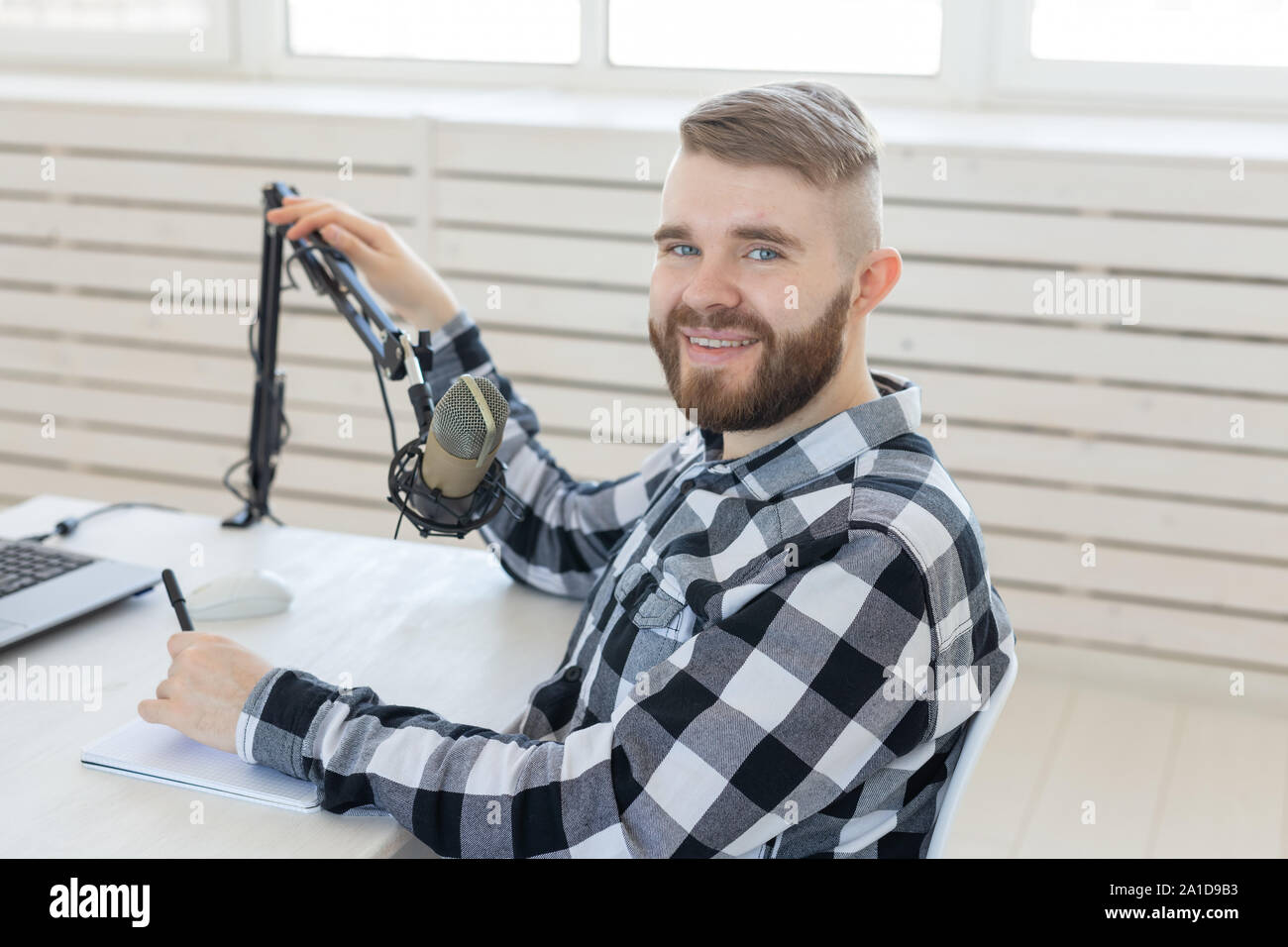 Radio, dj and people concept - young man presenter working on the radio ...