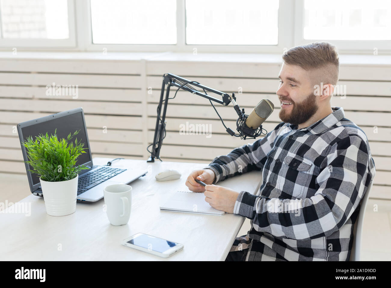 Radio host concept - Side view of handsome man working as radio host at ...