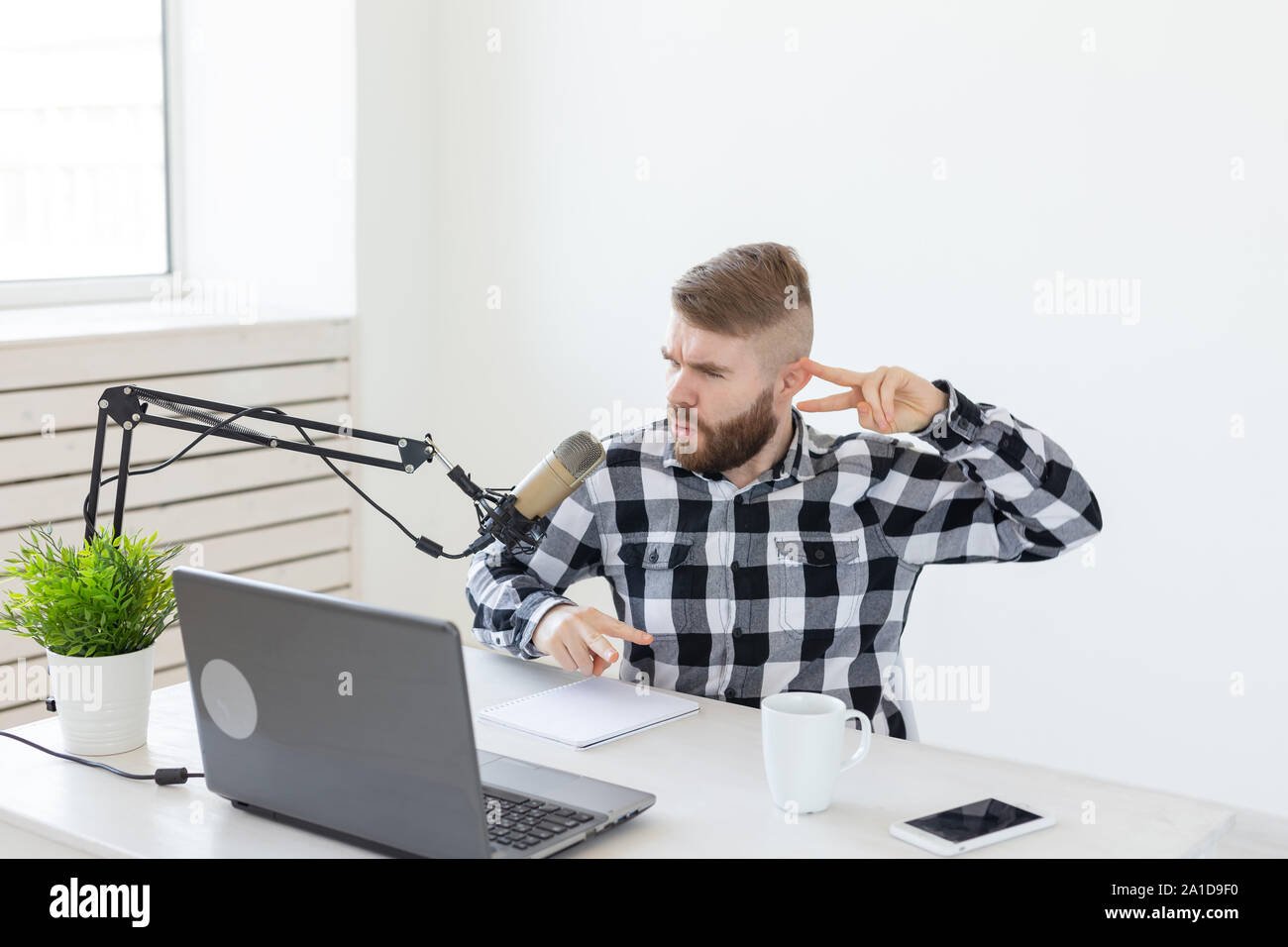 Radio host concept - Handsome man working as radio host at radio ...