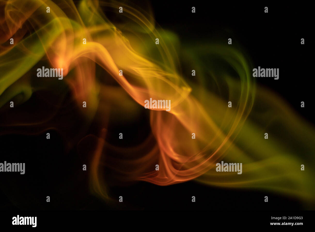 Yellow smoke, and red on black background Stock Photo - Alamy