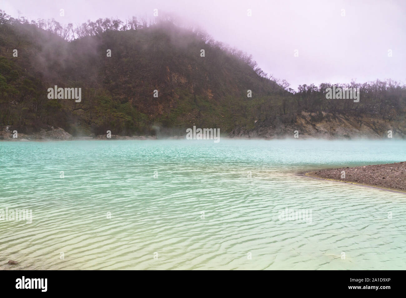 fog forming on the blue volcanic crater lake surface Stock Photo - Alamy