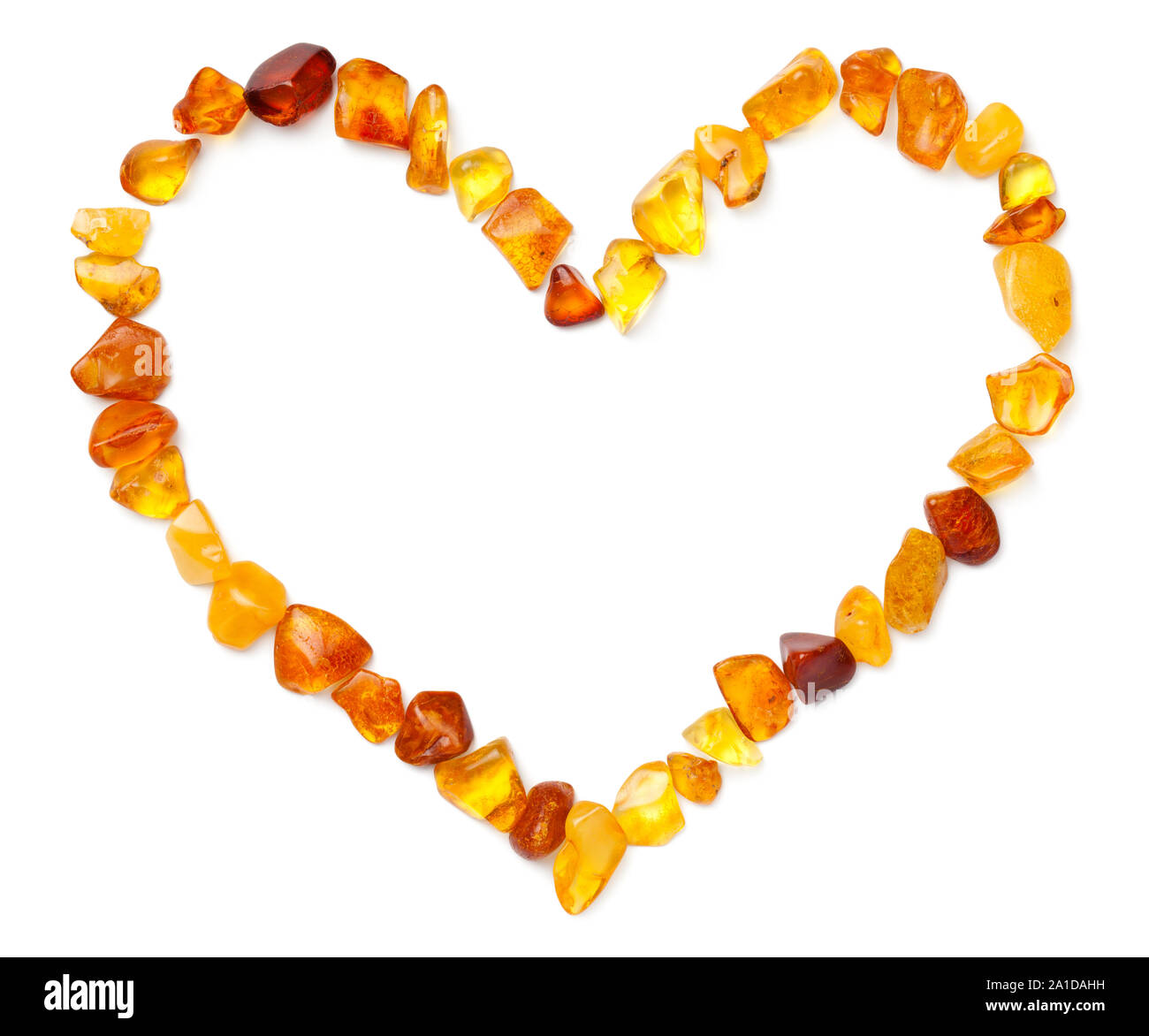 Heart shape made of amber isolated on white background. Polished ambers ...