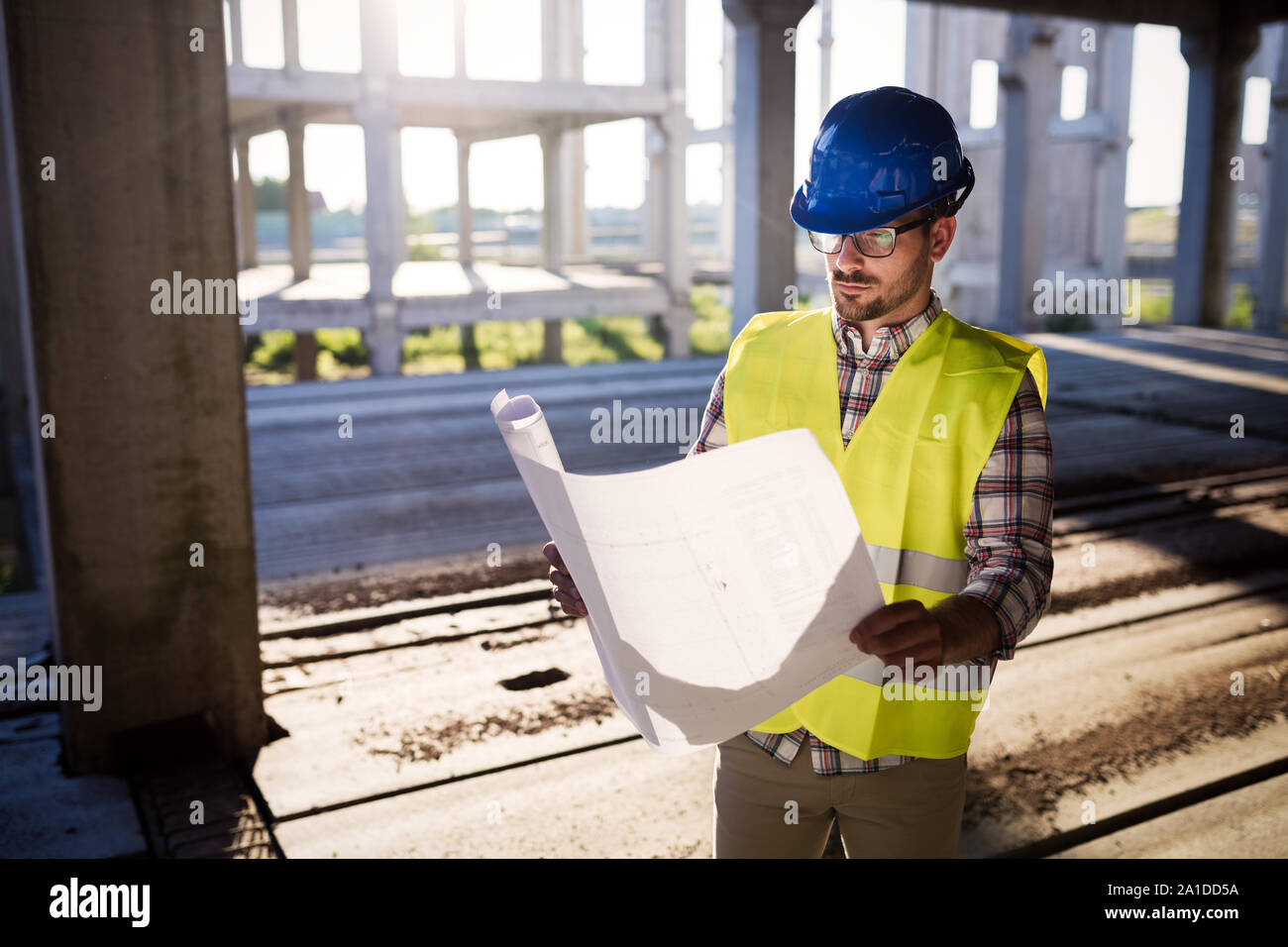 Picture of construction site engineer looking at plan Stock Photo - Alamy