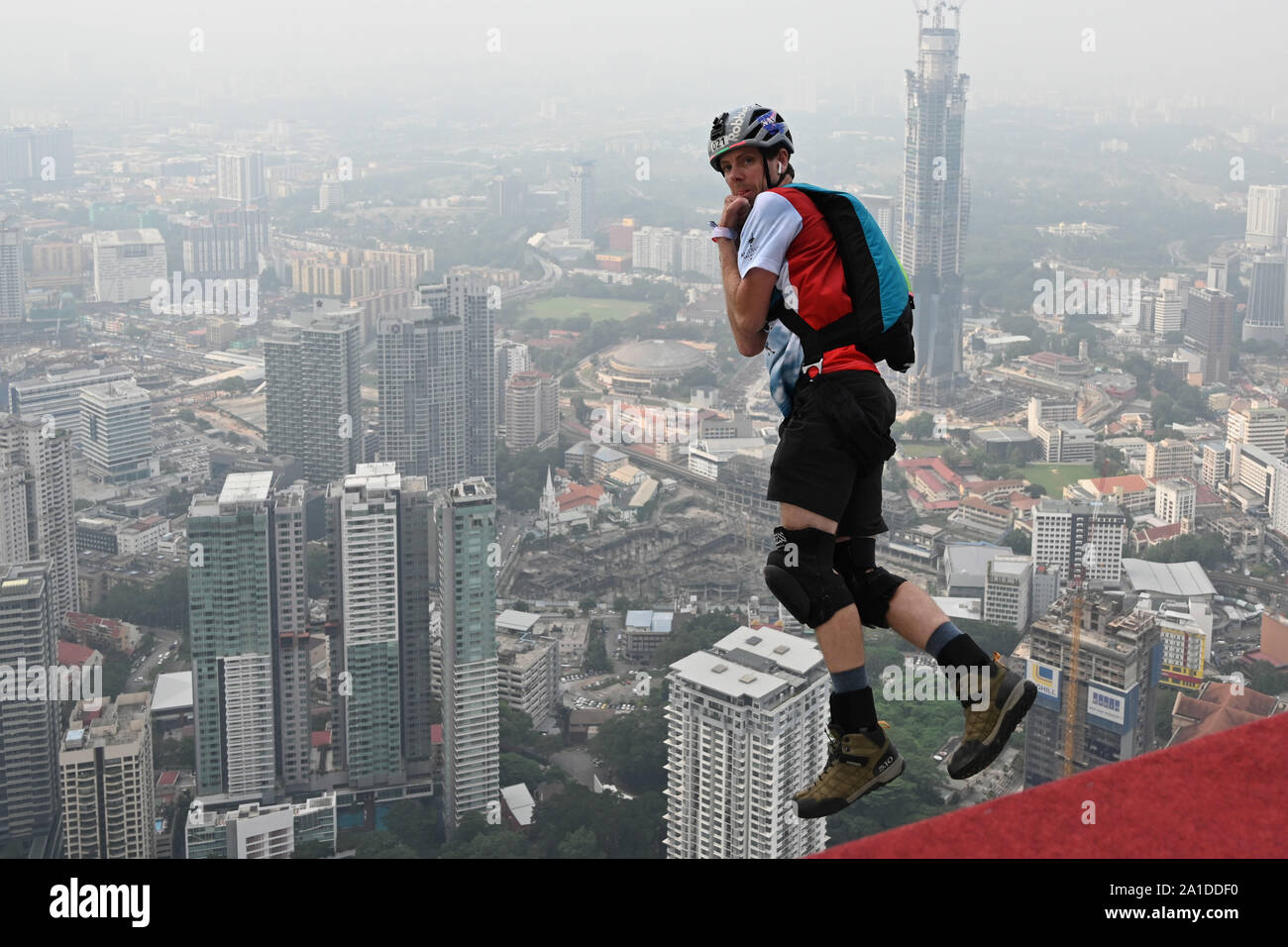 Kuala Lumpur, Malaysia. 26th Sep, 2019. A base jumper leaps from Kuala Lumpur Tower during the ...