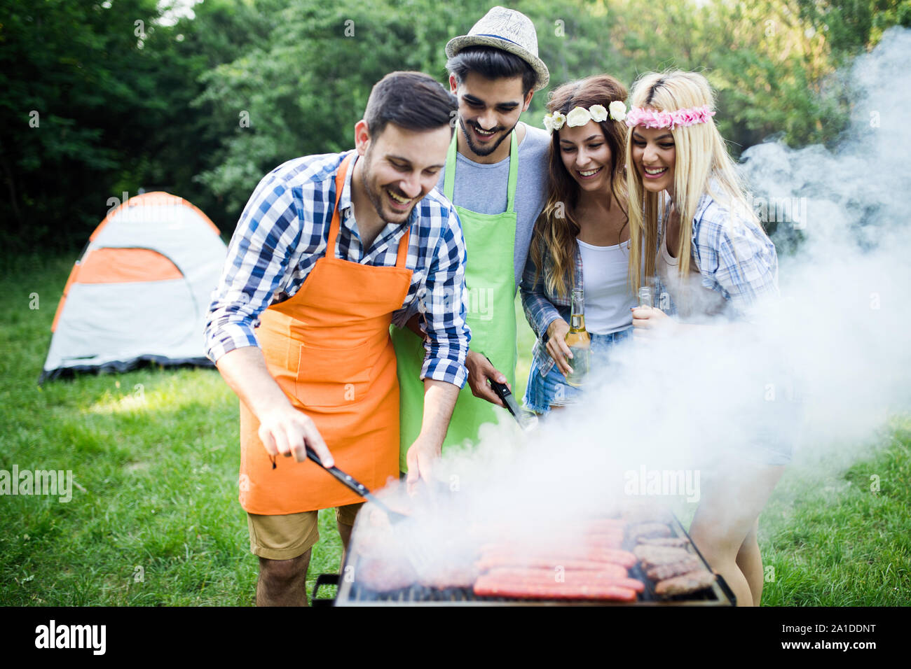 Group of friends having fun in nature doing bbq Stock Photo - Alamy