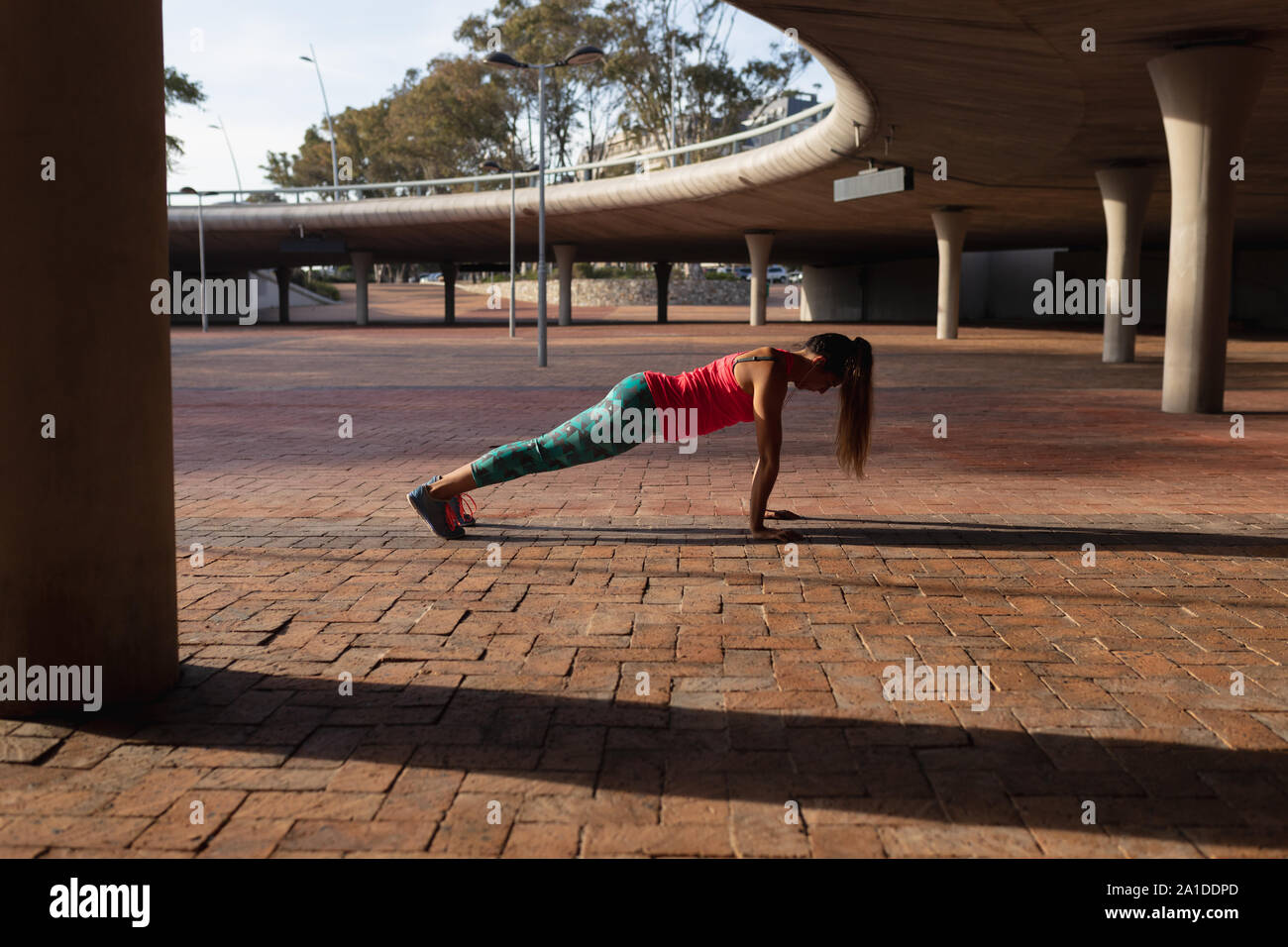 Woman exercising in a park Stock Photo - Alamy