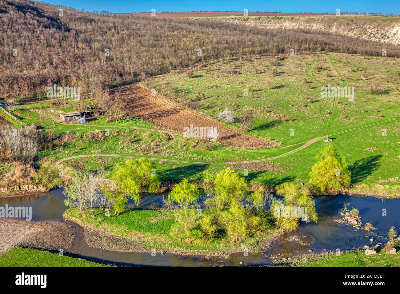 aerial view of green landscape with little river Stock Photo - Alamy