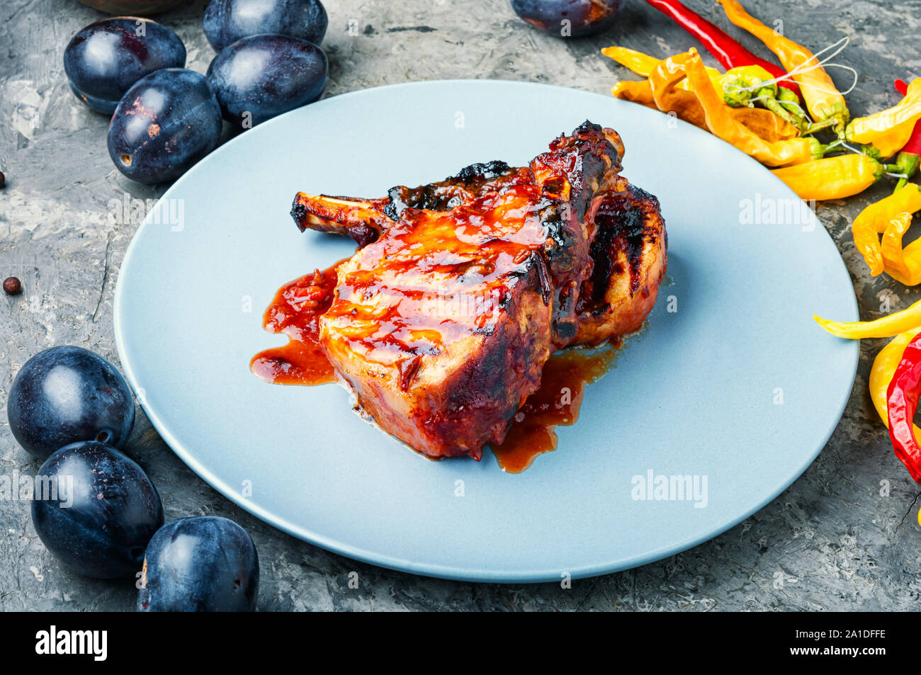Grilled meat on plate. Grilled meat with autumn plum.Bbq Stock Photo ...