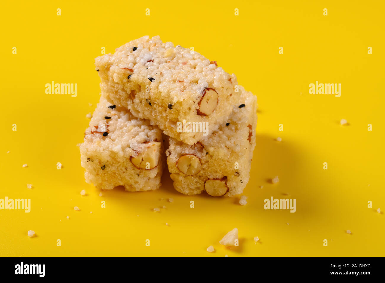 traditional Chinese crisp rice block with peanuts on yellow background ...