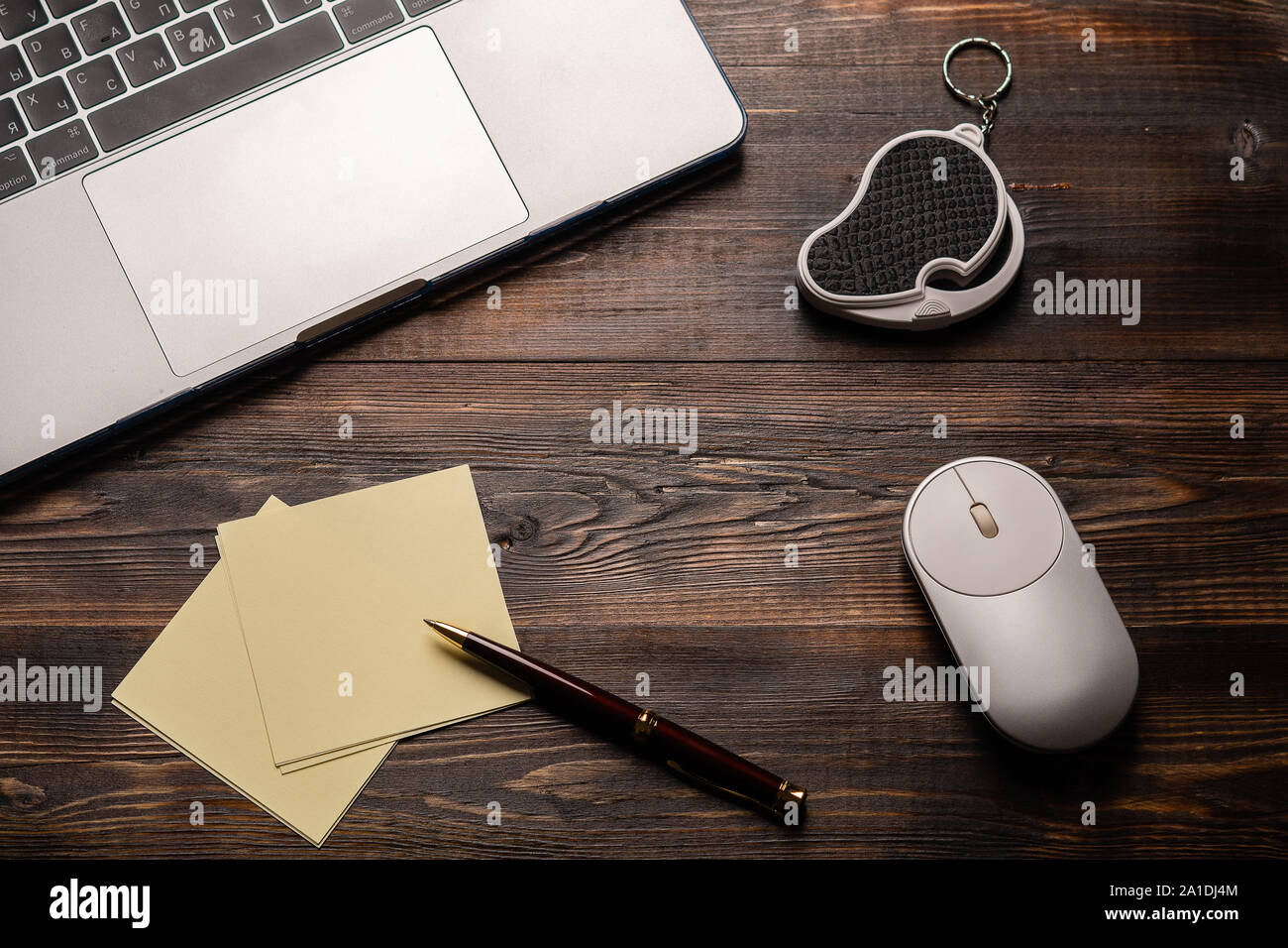 Laptop, magnifier, mouse, pen and paper for taking notes on the dark ...