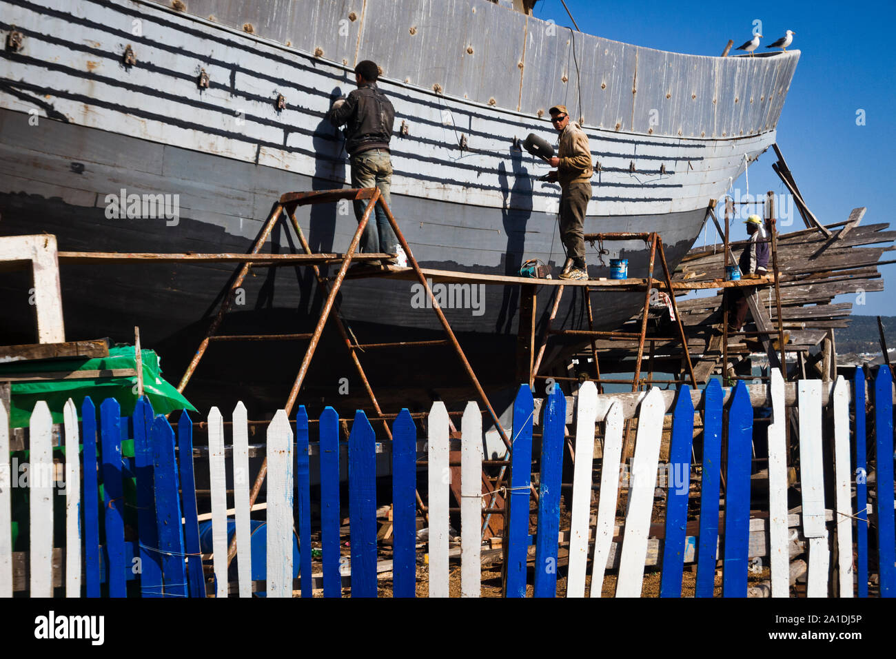 Repairing a boat in the dry dock at the port in Essaouira, Morocco ...