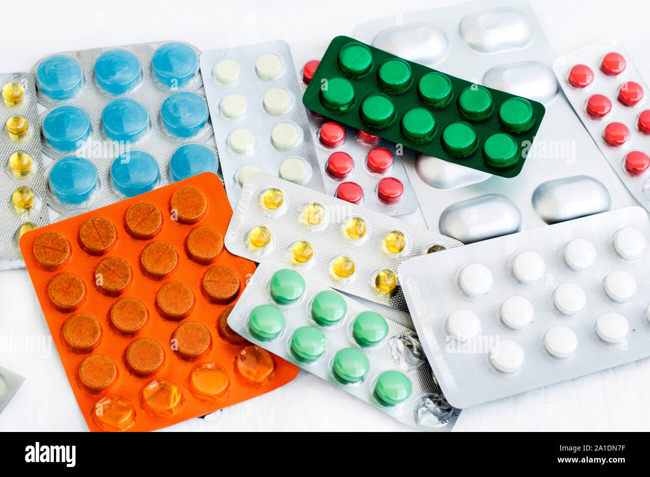 Different tablets of different colors on a white background Stock Photo ...