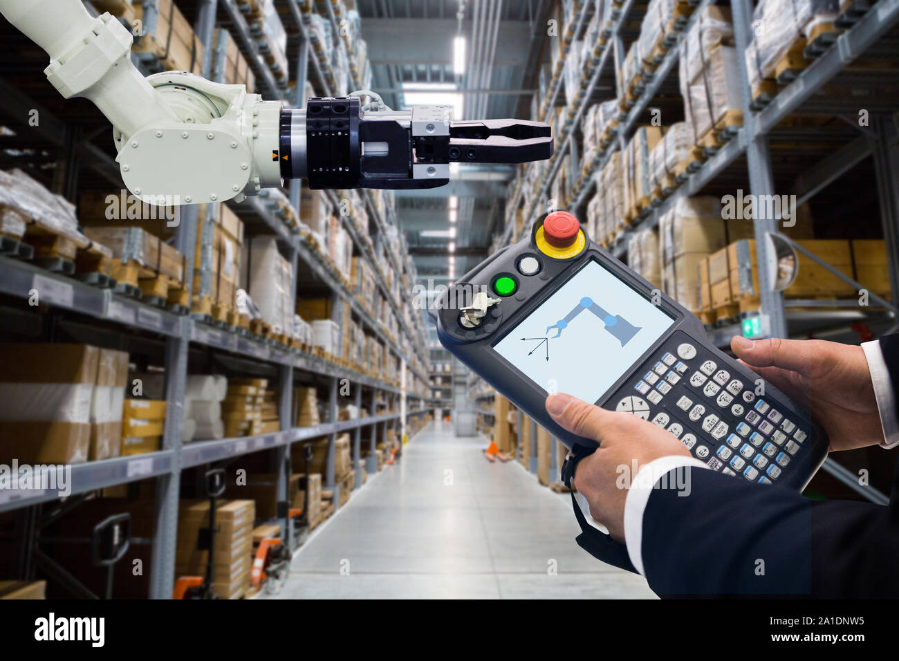 Engineer with teach pendant device. Programming robot with robotic arm ...