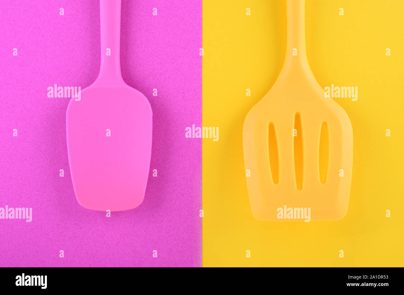 bright kitchen utensils on yellow and pink background, creative idea ...