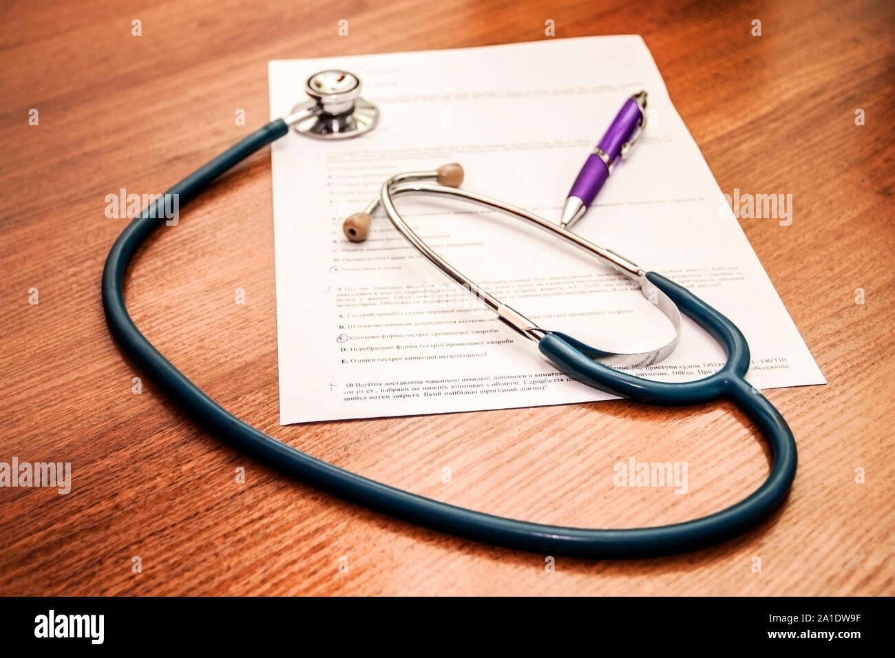 Stethoscope, sheet of paper, the pen on a desktop Stock Photo - Alamy