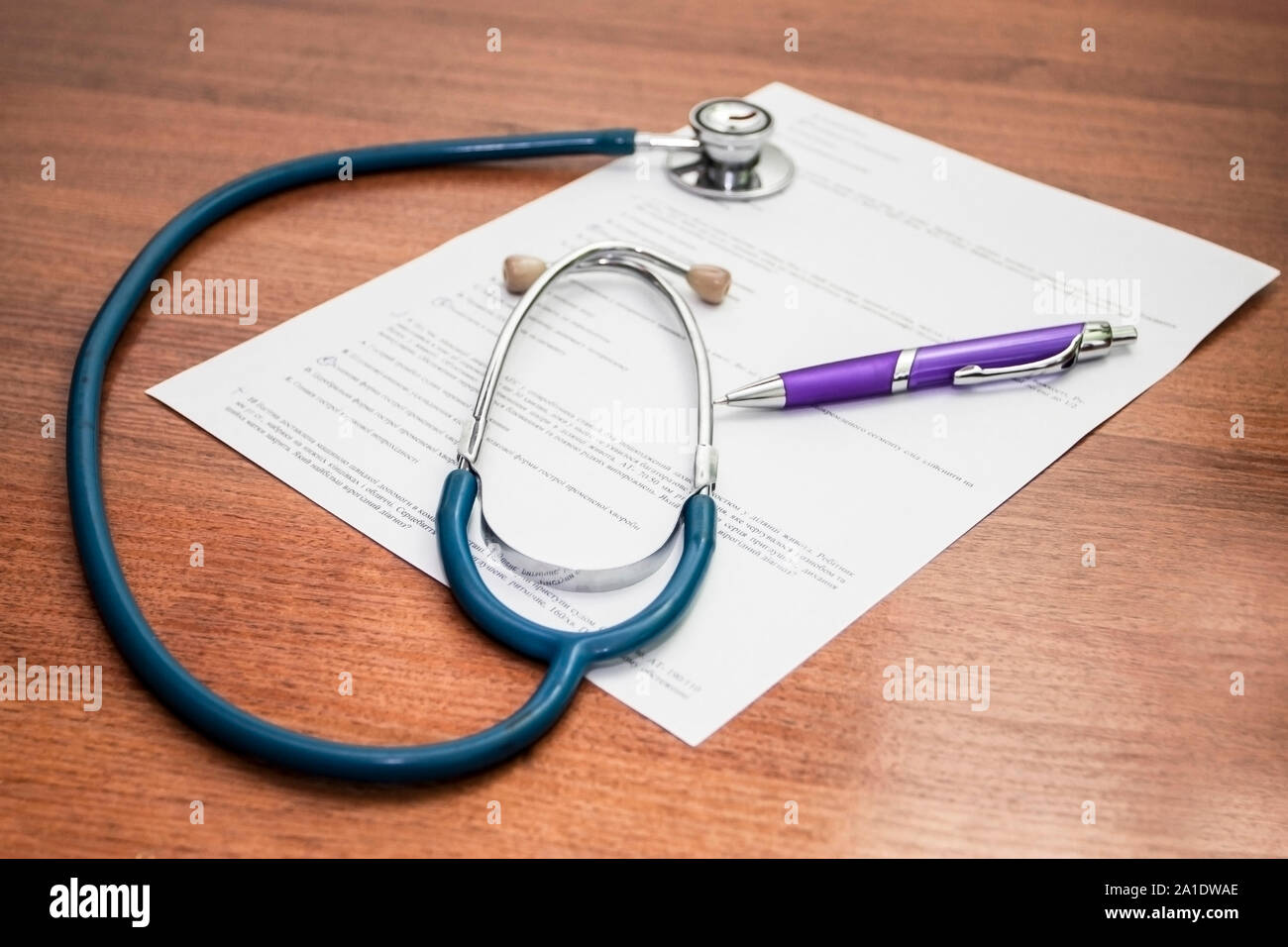 Stethoscope, sheet of paper, the pen on a desktop Stock Photo - Alamy