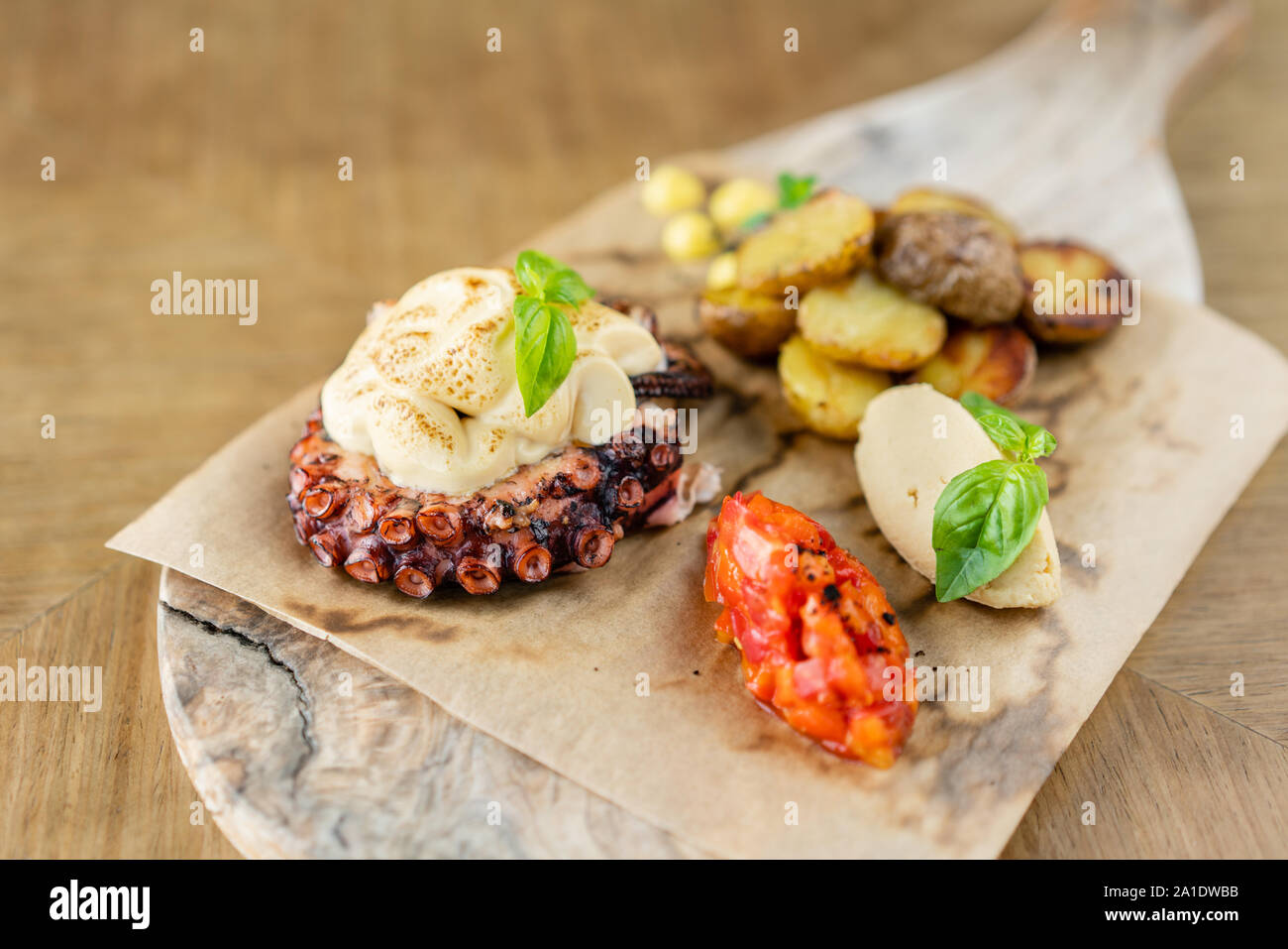 Roasted octopus BBQ with Baked potato. Wooden plate. Restaurant menu ...