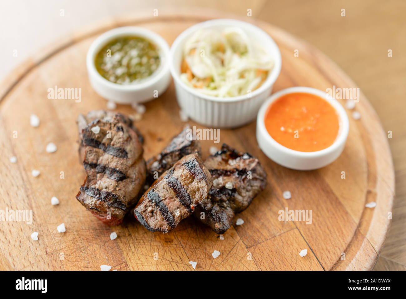 Pieces of liver cooked on the grill. Serving on a wooden Board ...