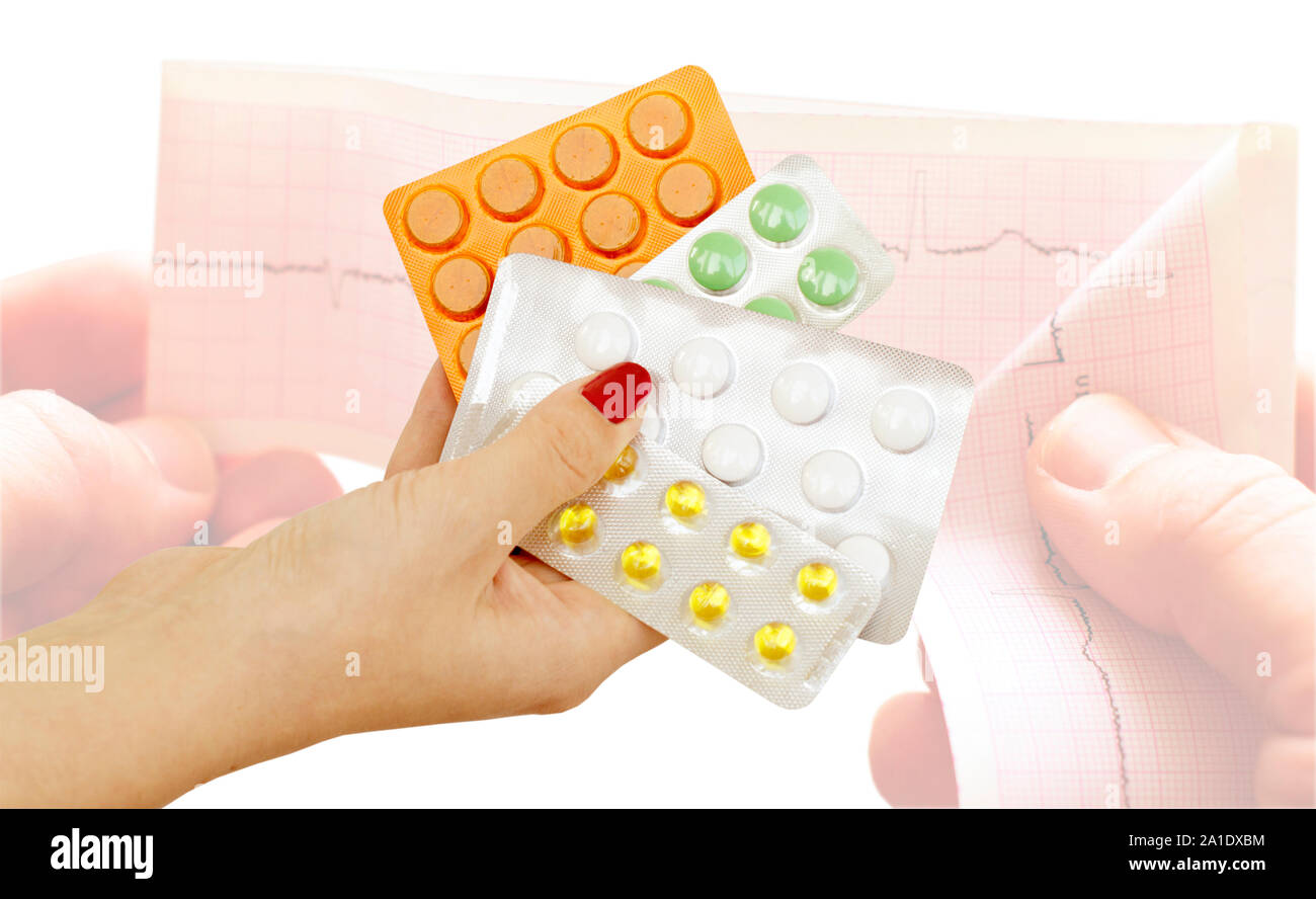 Different pharmaceutical tablets in women's hand on the background ...